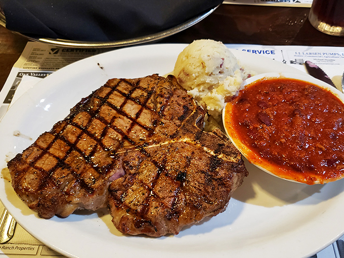 The Porterhouse doesn't just arrive &ndash; it makes an entrance. Those grill marks aren't decoration; they're a roadmap to flavor country.