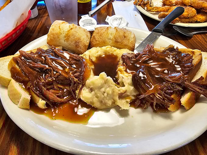 Open-faced pot roast sandwich that doesn't just fall apart – it surrenders completely, waving the white flag of tender, savory perfection.