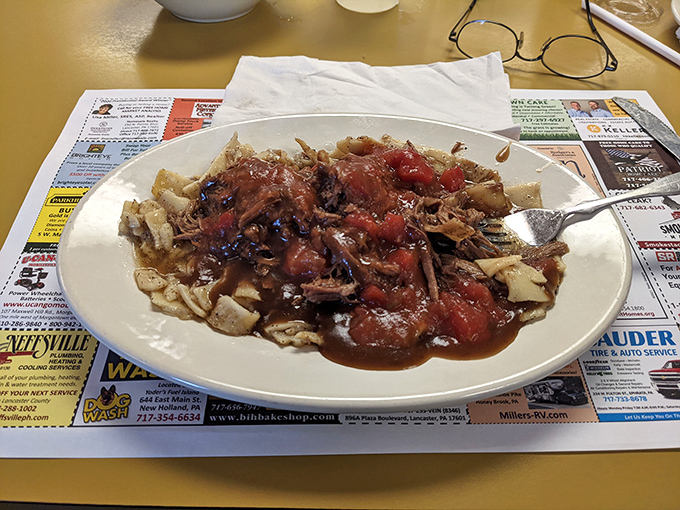 Pot roast that's clearly been slow-dancing with those tomatoes all day. The kind of comfort food that makes you want to hug the chef.