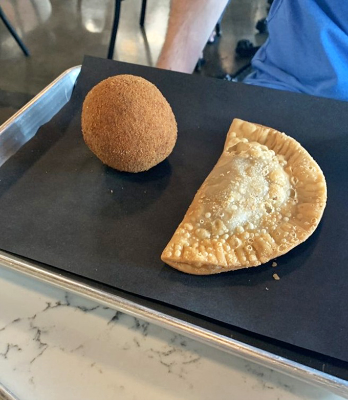 The potato ball and empanada duo: Tampa's answer to PB&J. These handheld treasures pack more flavor in one bite than most restaurants manage in an entire meal.