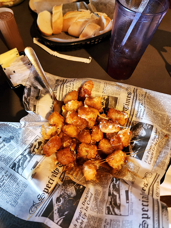 Crispy cheese curds nestled on newspaper&mdash;proof that sometimes the best culinary experiences come without fancy china or white tablecloths.