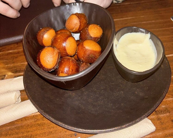 Pretzel bites with cheese sauce: proof that sometimes the simplest pleasures are the most profound. The warm, pillowy interior contrasts beautifully with the salty exterior.