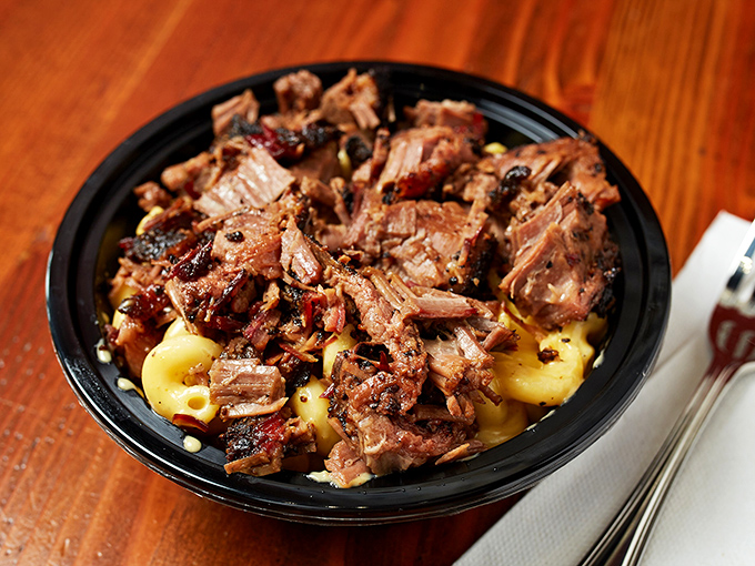 Mac and cheese becomes a throne for smoky pulled pork in this bowl of comfort that would make even your grandmother nod in approval.