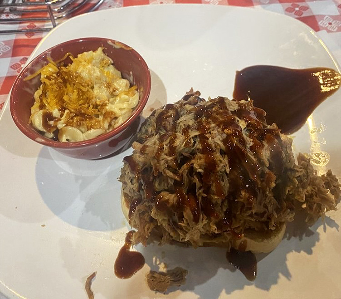 The pulled pork sandwich that launched a thousand cravings. Tender, saucy perfection on a bun with mac and cheese that demands equal attention.