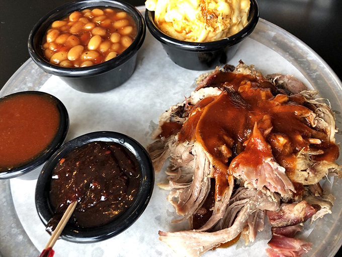 A pulled pork platter with sides that aren't afterthoughts. This tray represents the balanced diet of champions&mdash;meat and more meat, with beans for color.