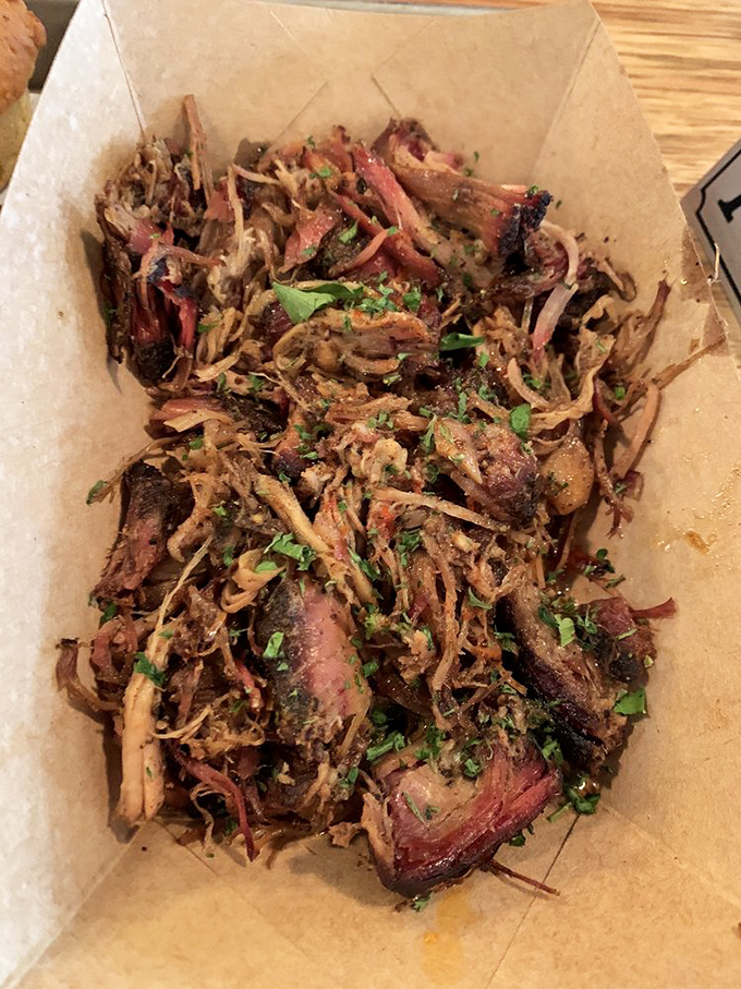Pulled pork that looks like it had a proper introduction to smoke before meeting your plate. Each strand tells a story of patience and precision.