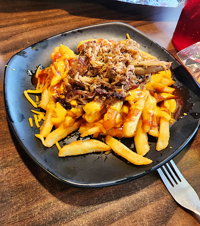 Golden pulled pork piled high on crispy fries creates the kind of comfort food that makes everything right.