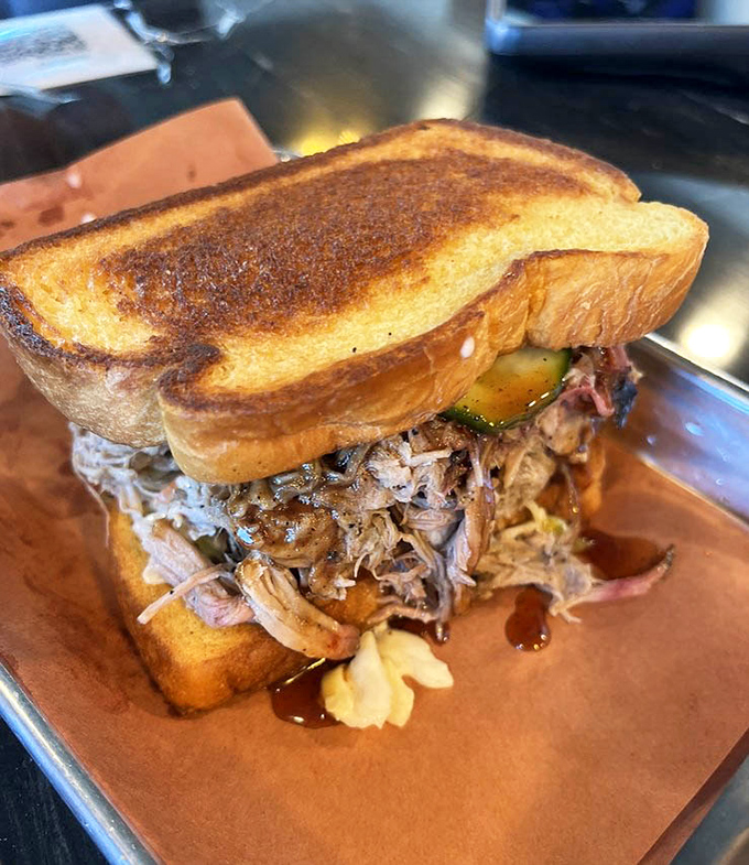 The pulled pork sandwich demonstrates why patience and proper smoking techniques create culinary magic every single time.