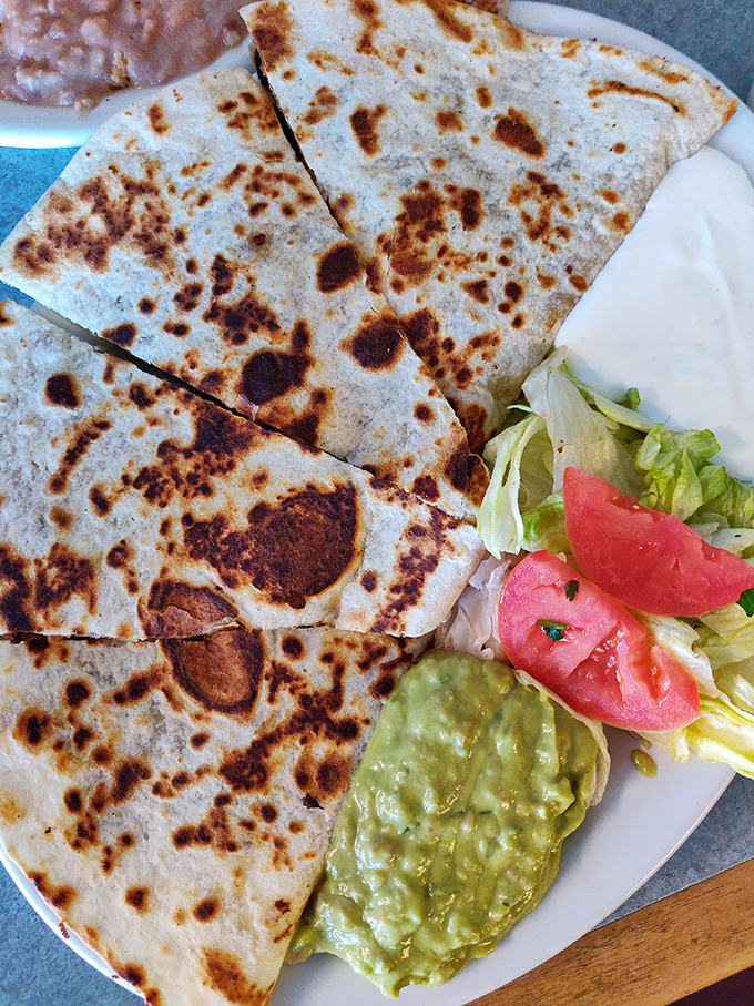 The humble quesadilla elevated to art form&mdash;perfectly crisped tortilla, melted cheese, and that dollop of guacamole waiting to take each bite to the next level.