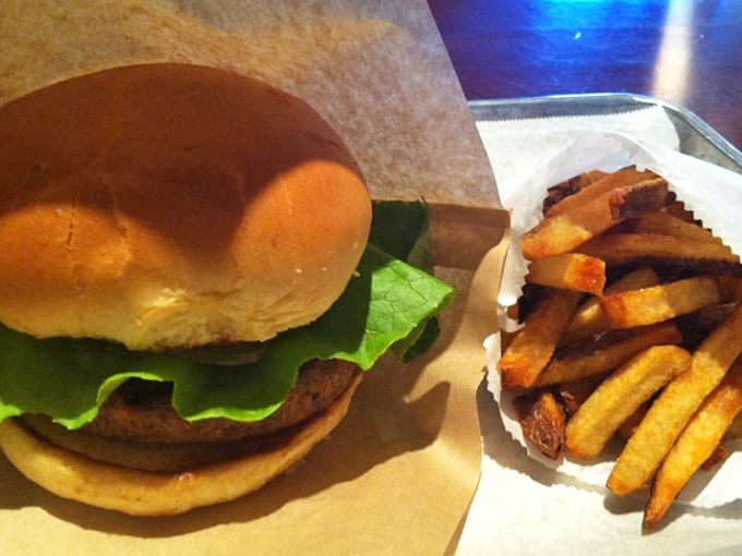 Simple yet satisfying—this classic burger with fresh lettuce proves that sometimes the straightforward approach delivers the most direct path to happiness.
