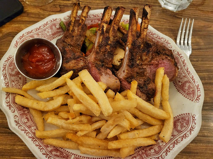 The rack of lamb stands proud, a testament to what happens when simple ingredients meet fire mastery and decades of experience.