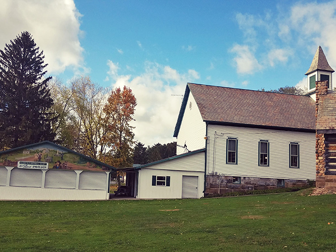 Simple white buildings against autumn skies tell stories of simpler times at the Ragersville Historical Society, where history isn't behind glass but feels wonderfully lived-in.