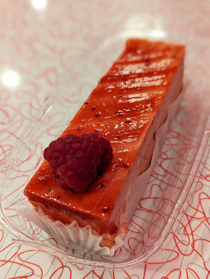 This raspberry cheesecake bar is wearing its finest red carpet attire, complete with a raspberry fascinator that screams "I'm the star here."