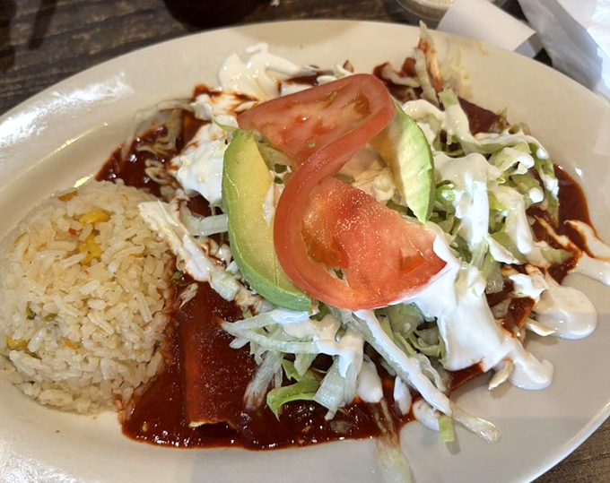 These enchiladas swim in a red sauce so good you'll be tempted to ask for a straw. Rice on standby to soak up every last drop.