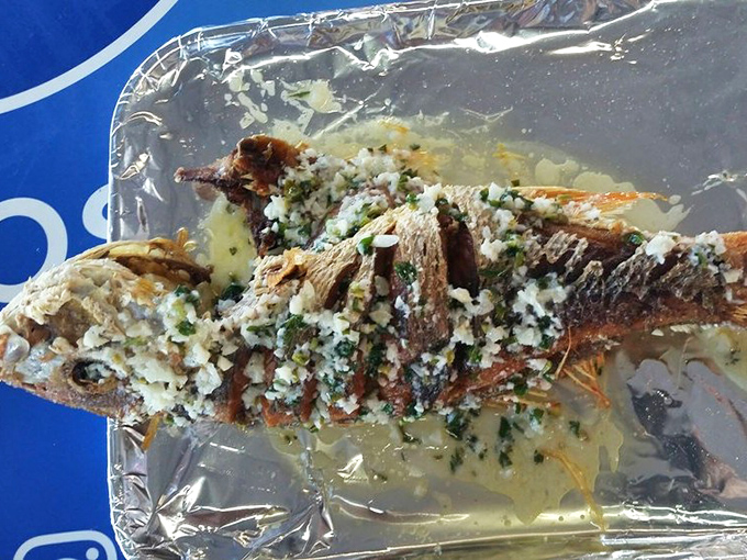 This whole fish, adorned with garlic and herbs, is the seafood equivalent of finding front-row concert tickets in your pocket.