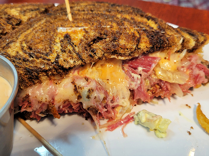 The Reuben reveals its glorious layers like geological strata of deliciousness. This isn't a sandwich; it's a masterclass in texture and flavor harmony.