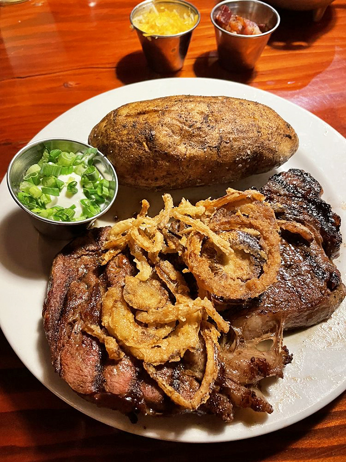A ribeye that could make a vegetarian weep, topped with crispy onion strings and paired with a baked potato dressed for a night out.