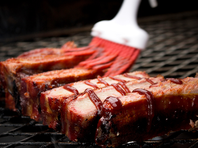These ribs aren't just cooked—they're coaxed, sweet-talked, and persuaded into a state of barbecue perfection over hours of patient smoking.