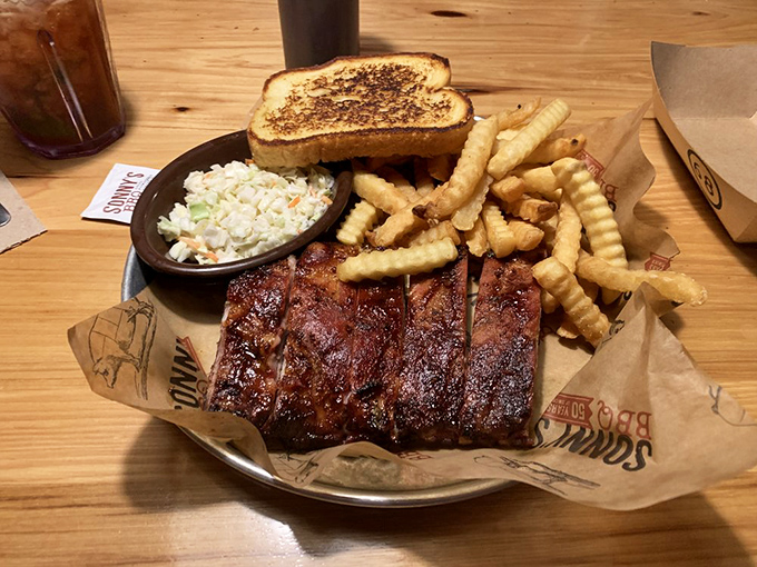 Ribs with that perfect bark, where the meat clings to the bone just enough to remind you it once had purpose beyond your plate.
