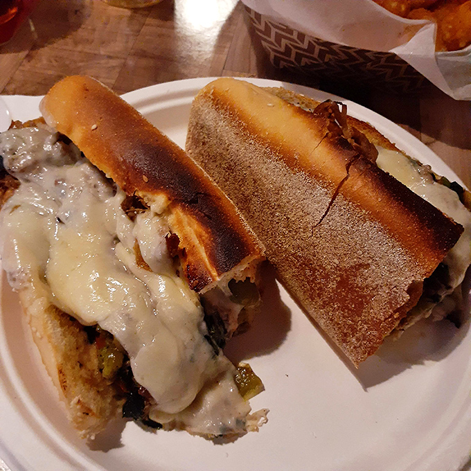 Sandwich architecture at its finest. The melted cheese cascading over perfectly seasoned meat creates a sight that makes waiting almost impossible.