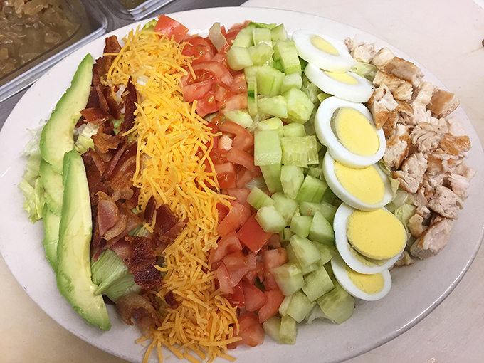A Cobb salad so perfectly arranged it could teach Marie Kondo a thing or two about organization. Each ingredient patiently waiting its turn.