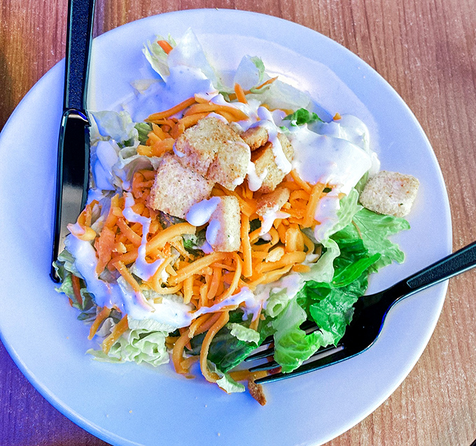 Even the salad gets star treatment here. Fresh greens, shredded cheese, and crunchy toppings prove vegetables can be more than just obligation eating.