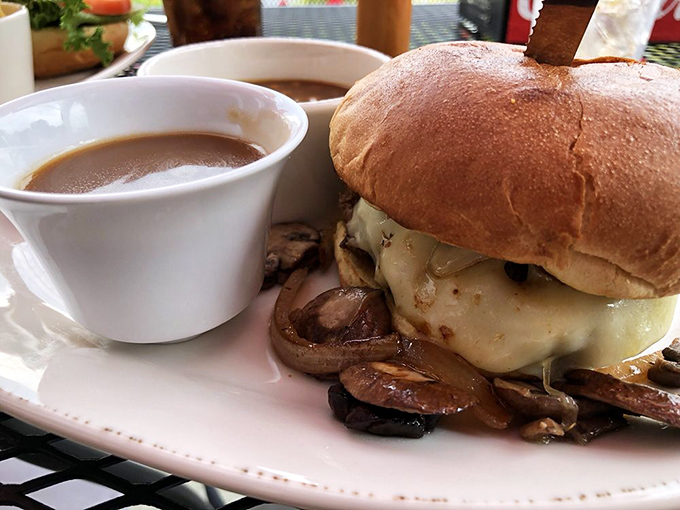 This isn't just a burger&mdash;it's architecture. Melted cheese cascading over mushrooms with a side of au jus for dunking? That's not lunch, that's therapy.