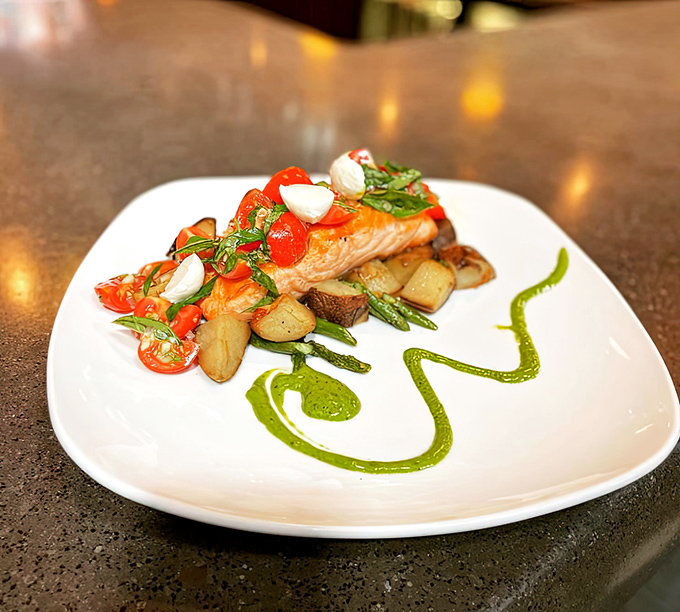 Salmon that's dressed better than most wedding guests, with a vibrant pesto swirl that's both art and flavor enhancement.