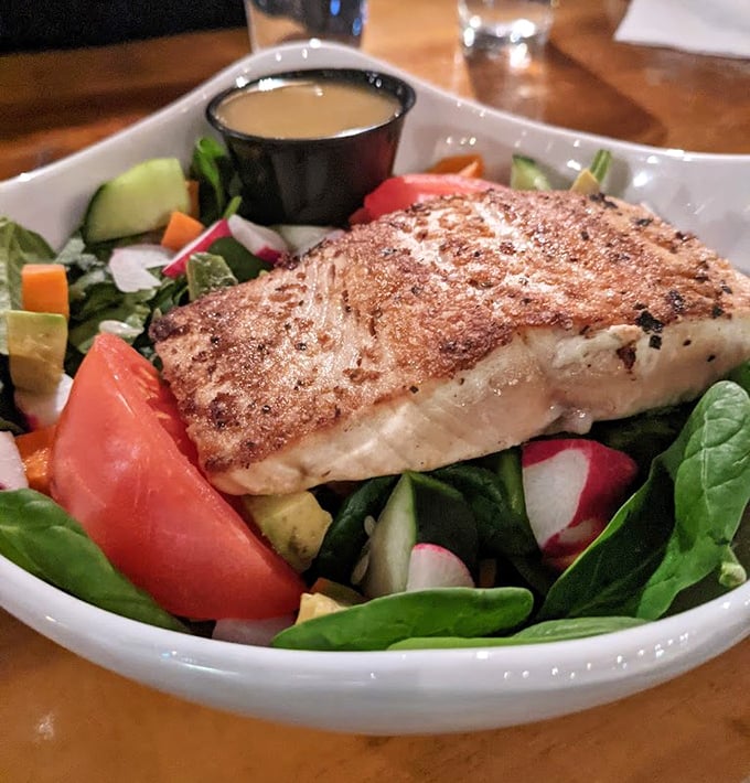 Who said healthy can't be heavenly? Perfectly seared salmon atop a garden of fresh vegetables – the kind of salad that doesn't feel like punishment.