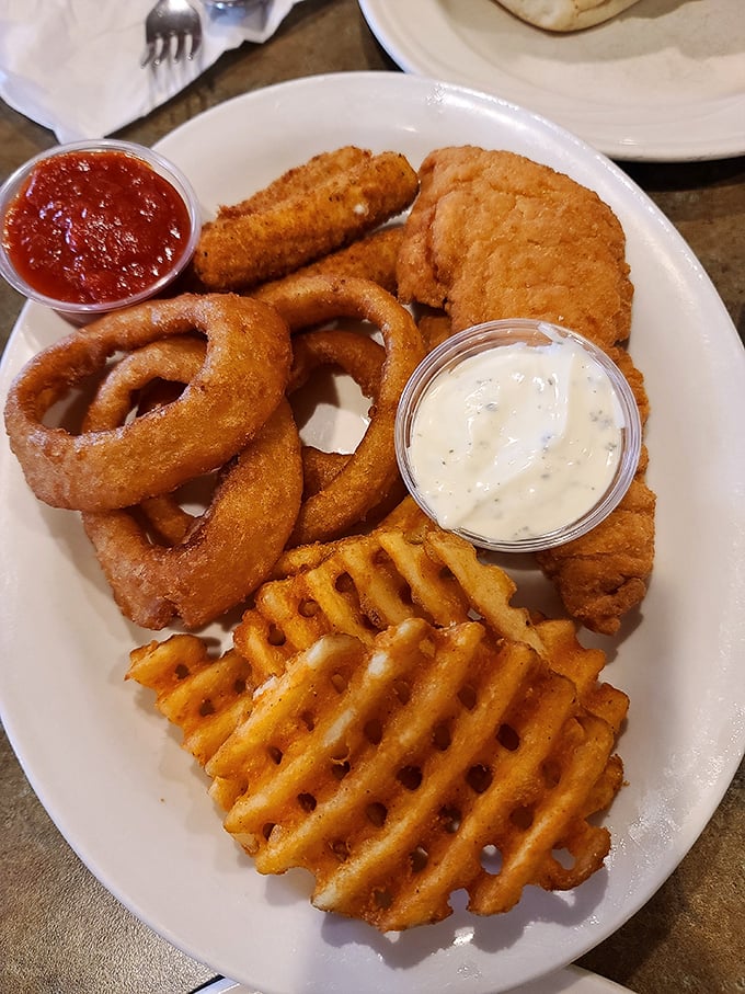The sampler platter: for when your appetite has commitment issues. Those onion rings have the perfect crunch-to-give ratio—engineering at its most delicious.