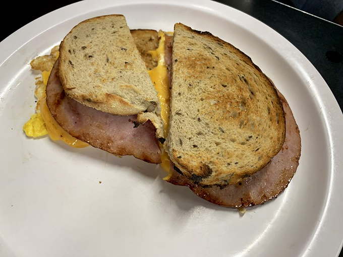 The humble breakfast sandwich elevated to art form&mdash;where thick-cut ham and melty cheese create morning magic between toasted bread.