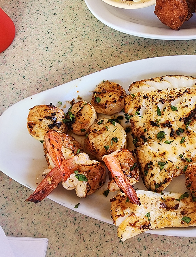 Perfectly blackened seafood that proves simplicity is the ultimate sophistication. Those scallops look like they jumped from ocean to grill to plate in record time.