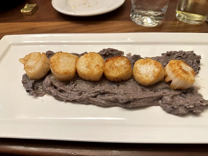 Perfectly seared scallops stand at attention on a bed of velvety mashed potatoes&mdash;Neptune's candy for the discerning seafood lover.