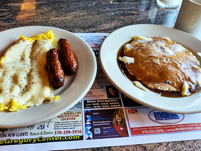 The breakfast power couple: golden scrambled eggs with sausage links alongside a pancake so perfect it deserves its own Instagram account.