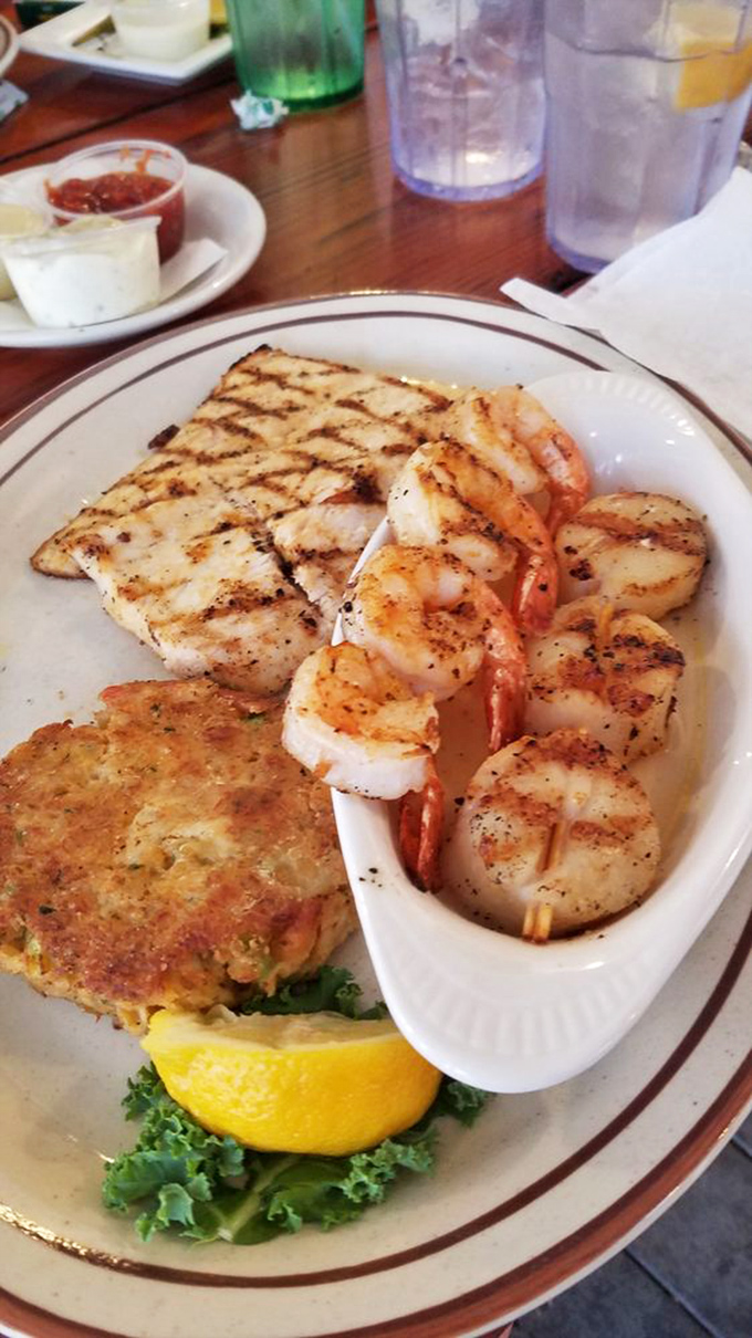 The seafood trifecta: perfectly grilled fish, succulent shrimp, and a crab cake that deserves its own fan club. The ocean's greatest hits album.
