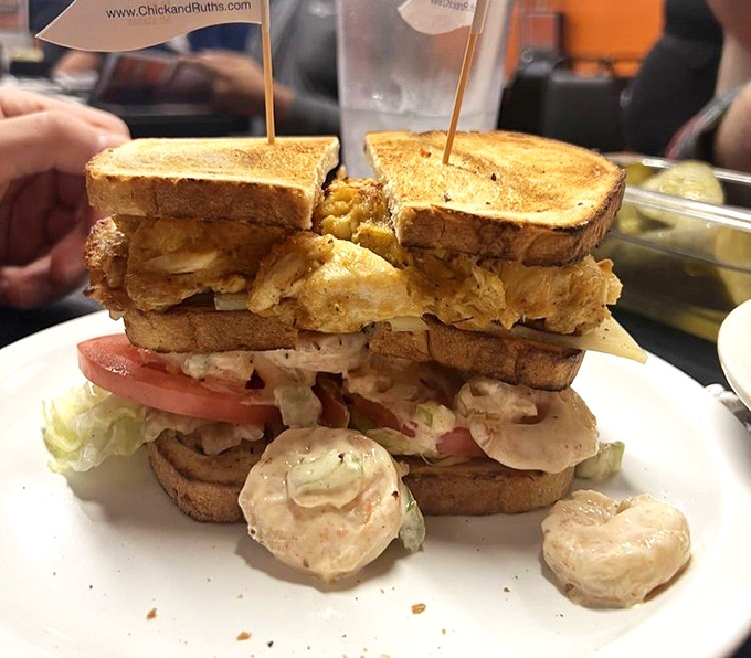 Architectural marvel or sandwich? This towering creation requires both an appetite and a strategy to conquer successfully.