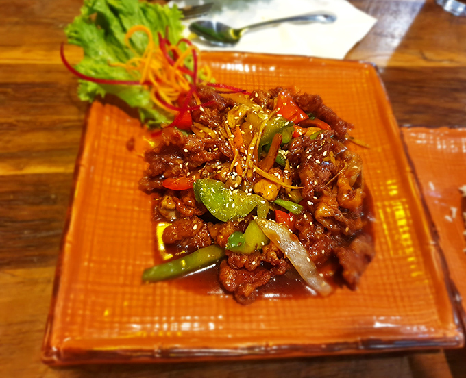 This isn't just duck&mdash;it's duck that went to finishing school. Glazed to perfection and surrounded by vibrant vegetables in a sauce worth bottling.