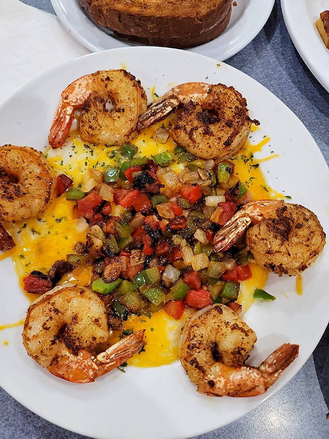 Shrimp and grits elevated to art form, where perfectly seasoned seafood meets creamy Southern comfort in harmony.