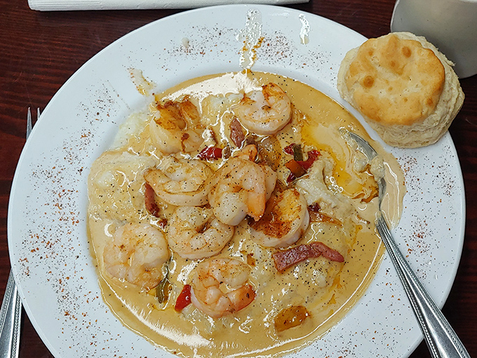 Shrimp and grits: where coastal bounty meets country comfort. Those plump shrimp swimming in creamy goodness make resistance completely futile.