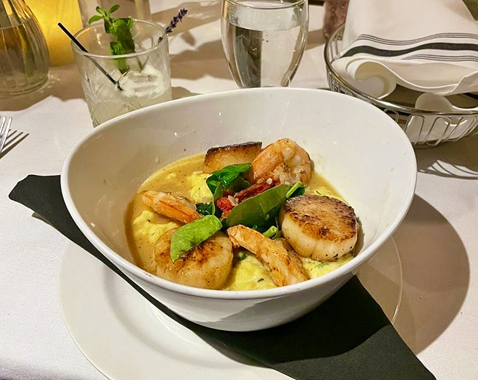 Shrimp and scallops lounging in risotto like they're at a seafood spa&mdash;comfort food that somehow managed to get an advanced degree.