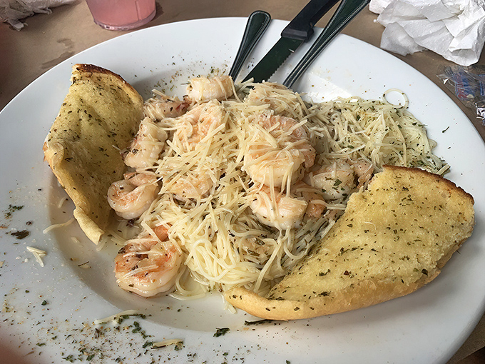Shrimp scampi that's having a love affair with parmesan. The garlic bread is just there to chaperone this delicious romance.