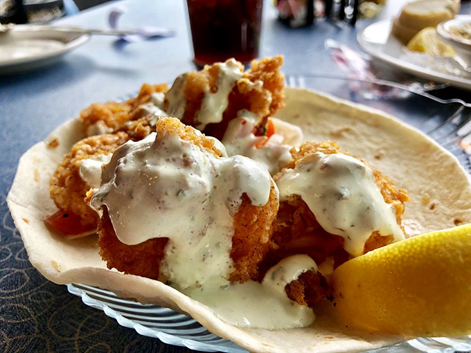 Crispy fried shrimp nestled in a shell and drizzled with creamy sauce&mdash;proof that sometimes the simplest pleasures deliver the biggest smiles.