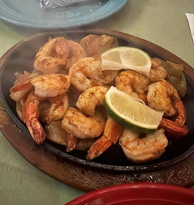 Gulf shrimp fajitas arrive on a platter hot enough to announce their presence from three tables away.