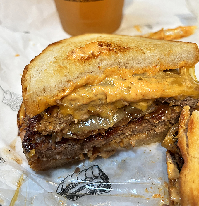 A cross-section that reveals the soul of a sandwich. The melted cheese embraces the brisket like they were destined to be together in this edible love story.