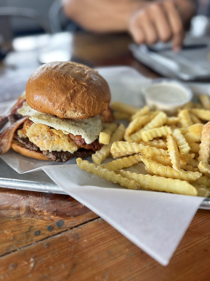 The burger that launched a thousand cravings. Melty cheese cascades over a perfectly seared patty, while those crinkle fries stand at attention, ready for duty.