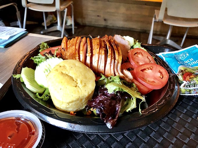 Smoked turkey sliced with surgical precision, a cornbread muffin standing at attention, and fresh greens that didn't give their lives in vain.