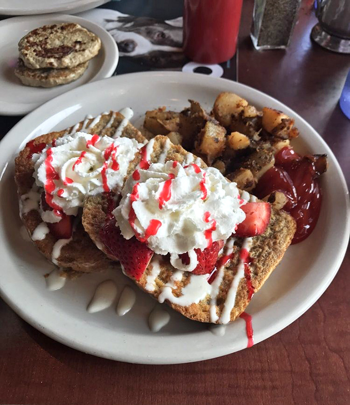 Strawberry French toast that looks like it should be on a magazine cover. Whipped cream, fresh berries, and a drizzle that makes you forget you're technically eating bread.
