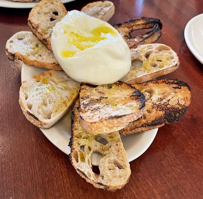Sourdough that's been through more character development than most Netflix series&mdash;charred, chewy, and ready for its close-up with that ball of burrata.