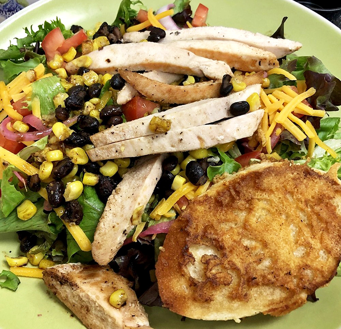 A salad that actually satisfies—protein, veggies, and that crispy disk of bread that makes you forget you ordered something healthy.