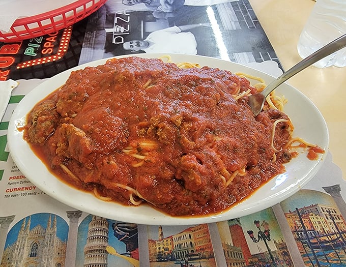 This isn't just spaghetti and meatballs; it's a mountain of pasta supporting boulders of seasoned beef under a lava flow of decades-perfected sauce.